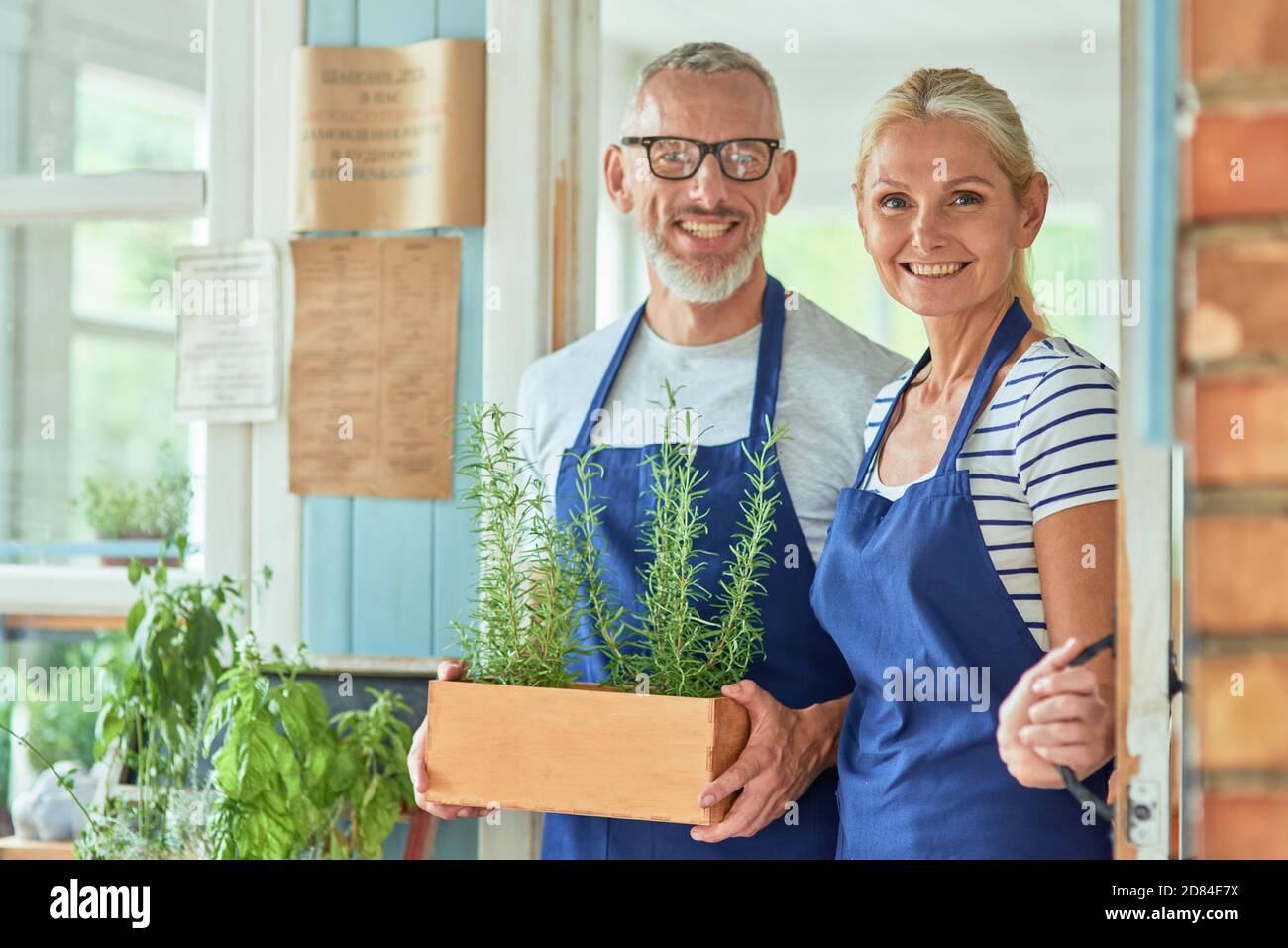 Middle aged caucasian partners standing at garden house door Stock ...