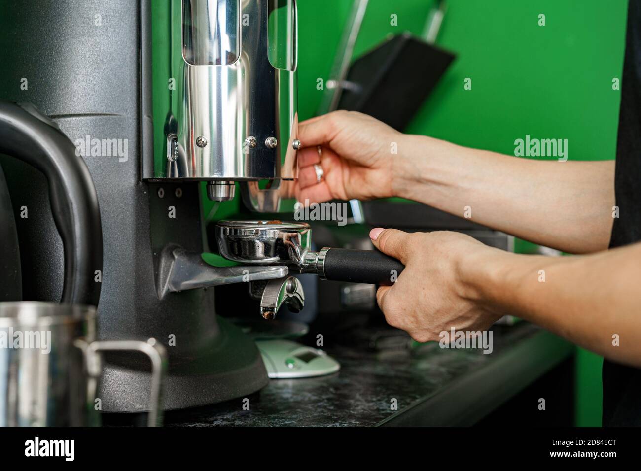 Woman coffee shop worker preparing coffee on professional coffee ...