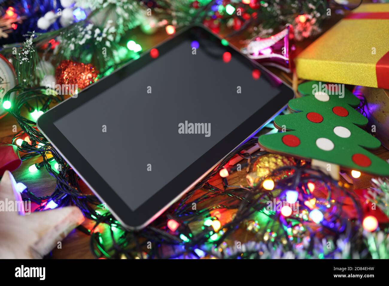 On table is tablet and New Year's decorations Stock Photo - Alamy