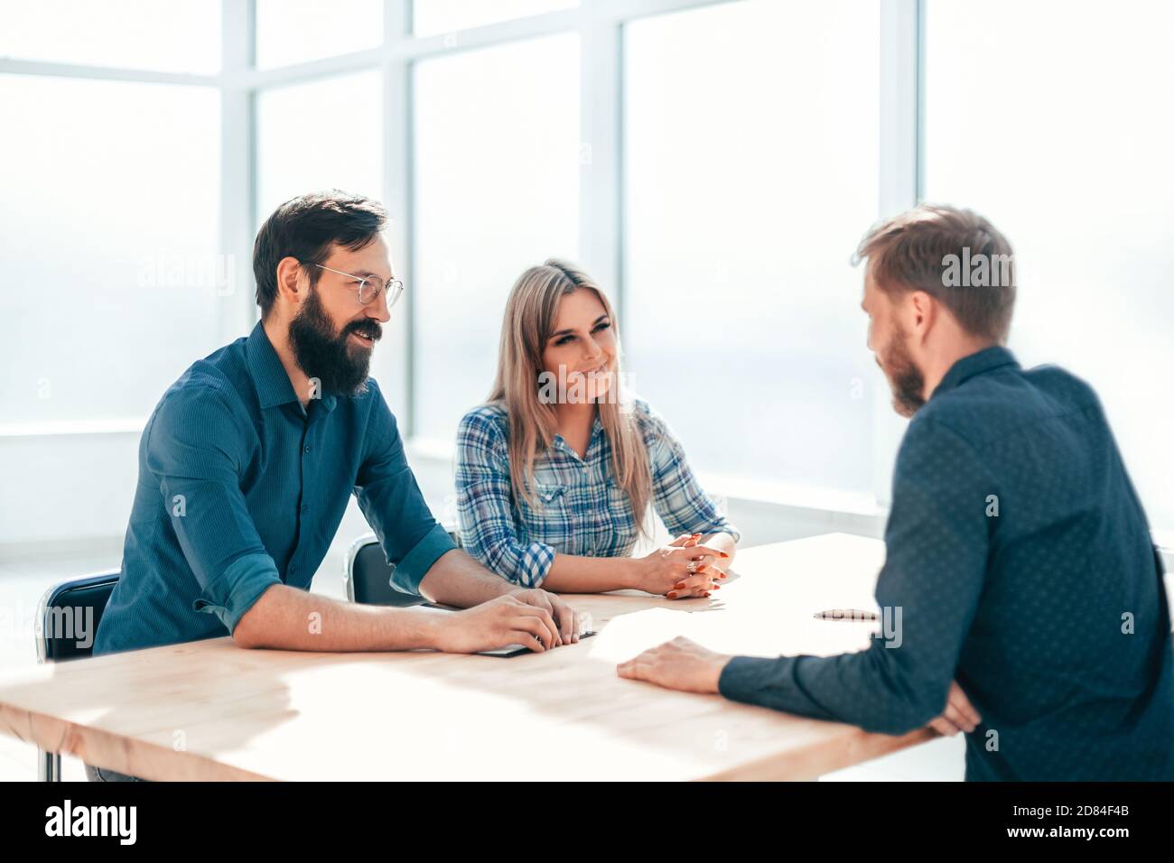 group of successful young people sitting at the negotiating table Stock ...
