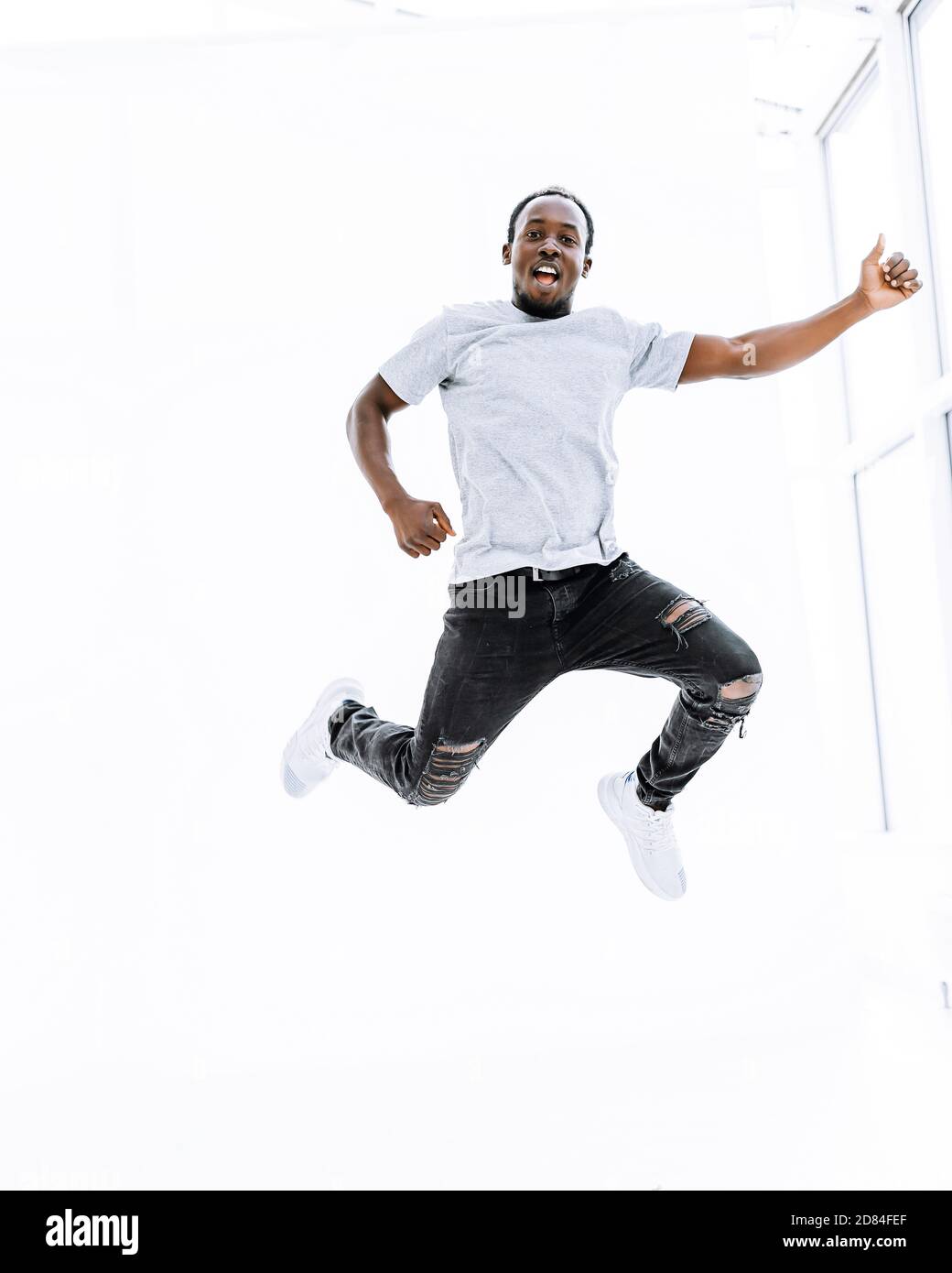 in full growth. happy dancing guy showing thumbs up Stock Photo - Alamy