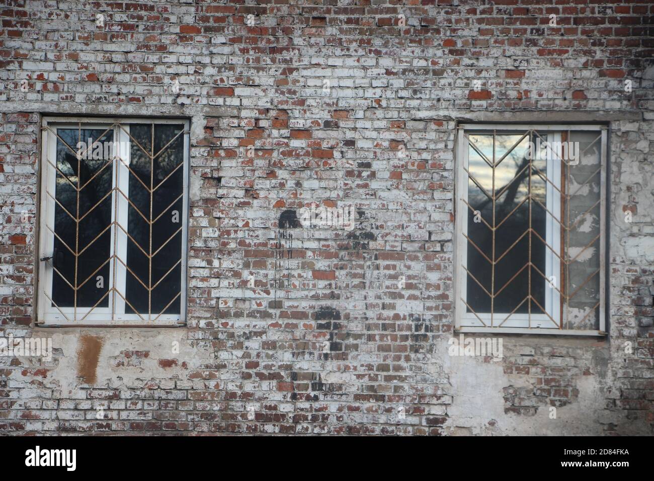 Old grunge wall and two windows. Fragment of old house. real estate ...