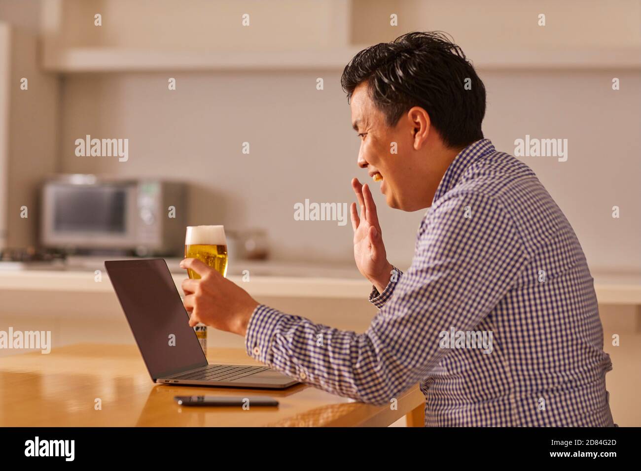 Japanese man drinking at home remote drinking Stock Photo - Alamy
