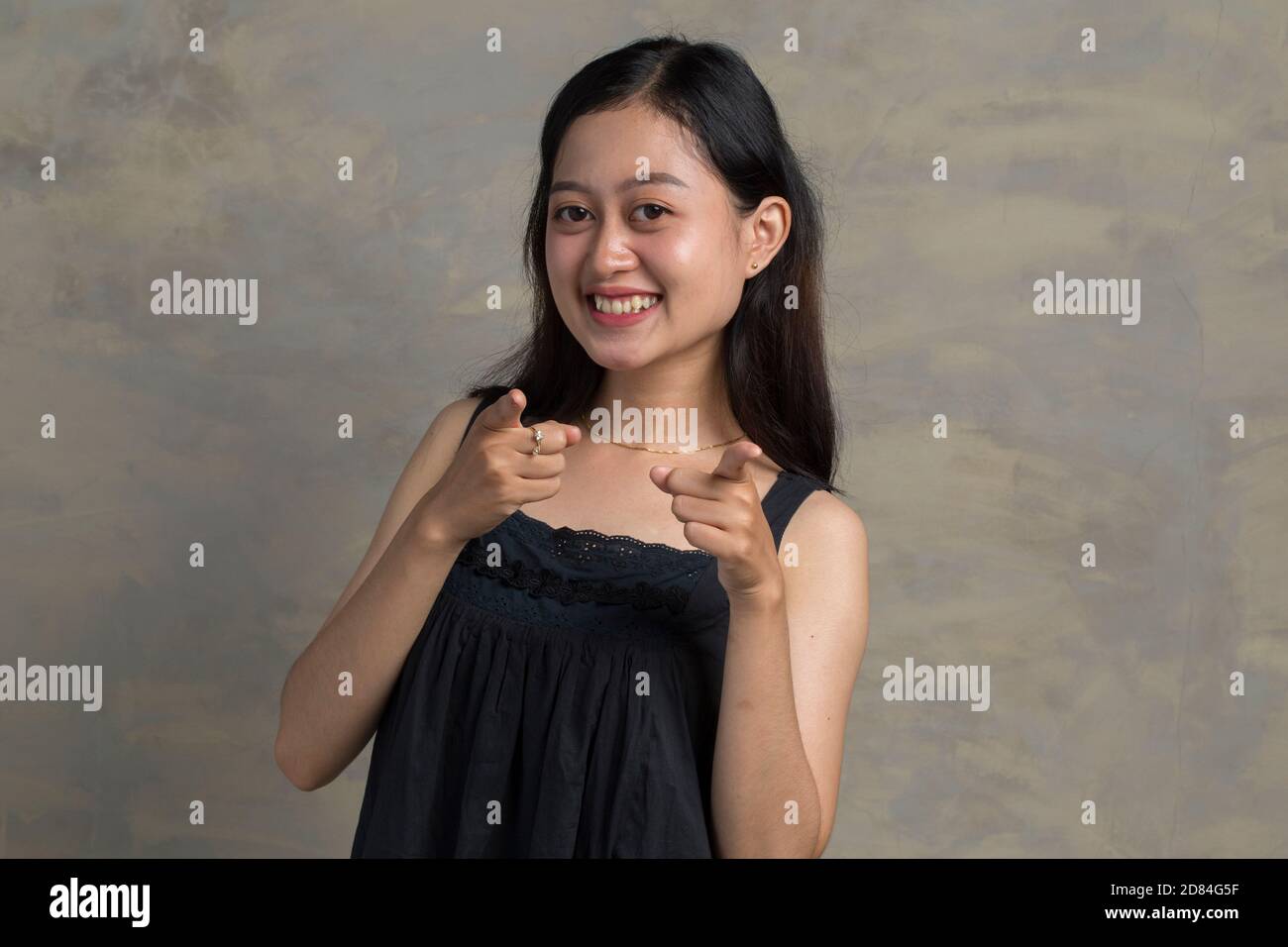 portrait of beautiful asian woman smiling while pointing forward Stock ...