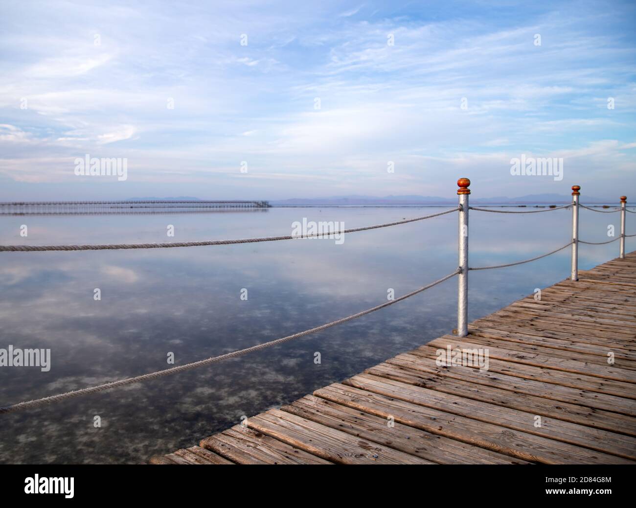 The background is a beautiful long wooden pier. close-up on sunset ...
