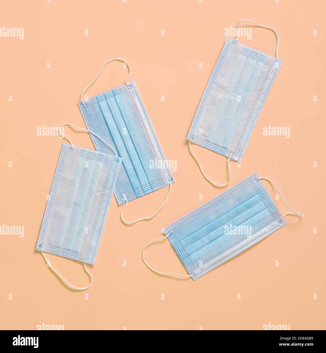 medical face masks on beige paper background, top view Stock Photo - Alamy