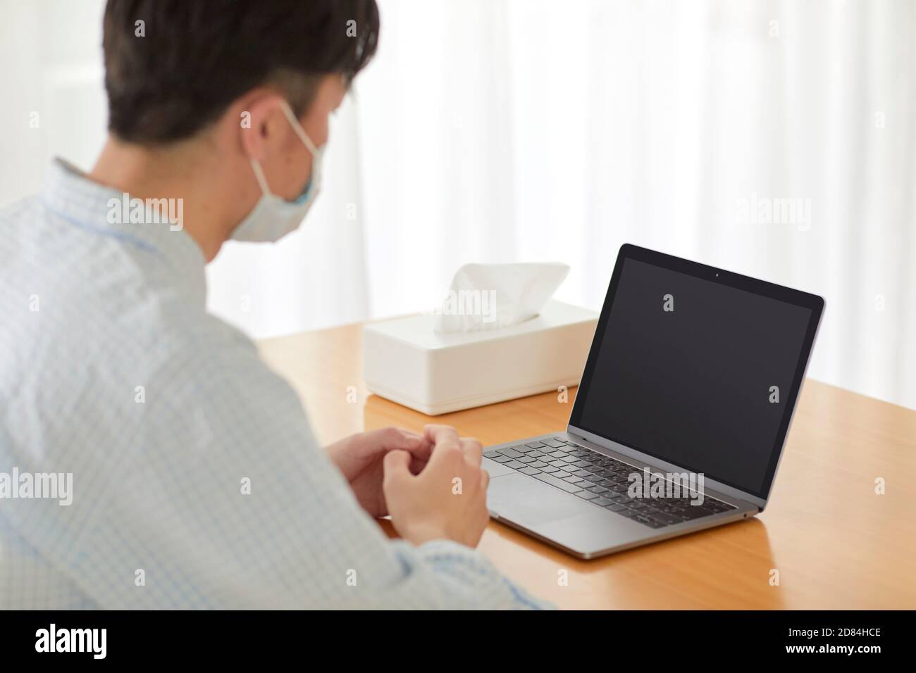 Sick Japanese man working from home Stock Photo - Alamy