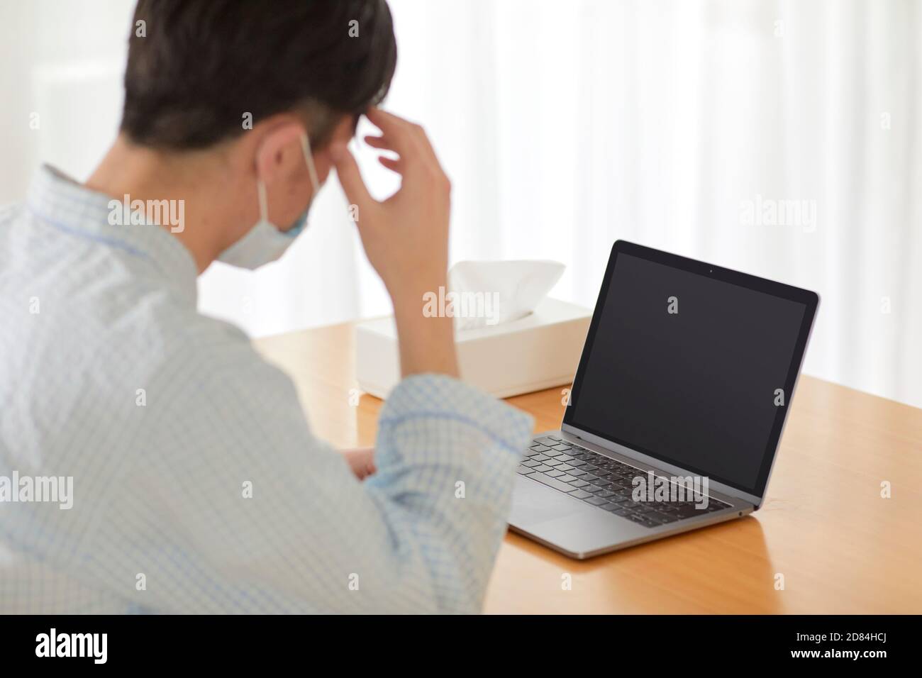 Sick Japanese man working from home Stock Photo - Alamy