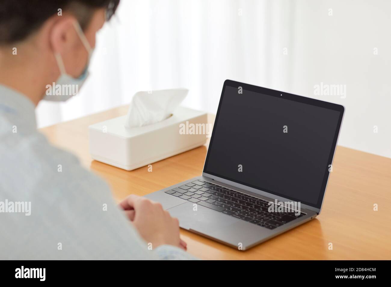 Sick Japanese man working from home Stock Photo - Alamy