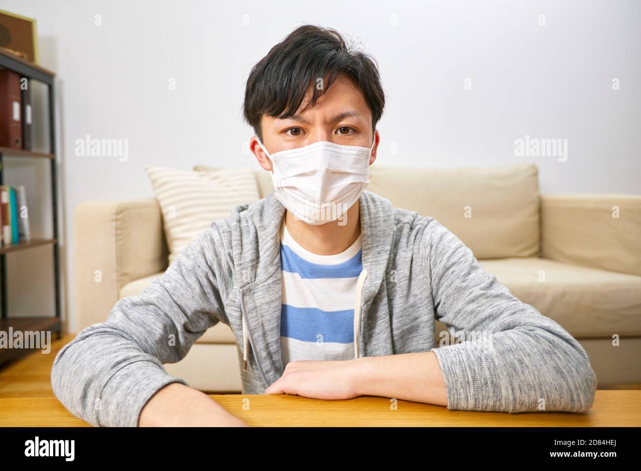 Sick Japanese man working from home Stock Photo - Alamy