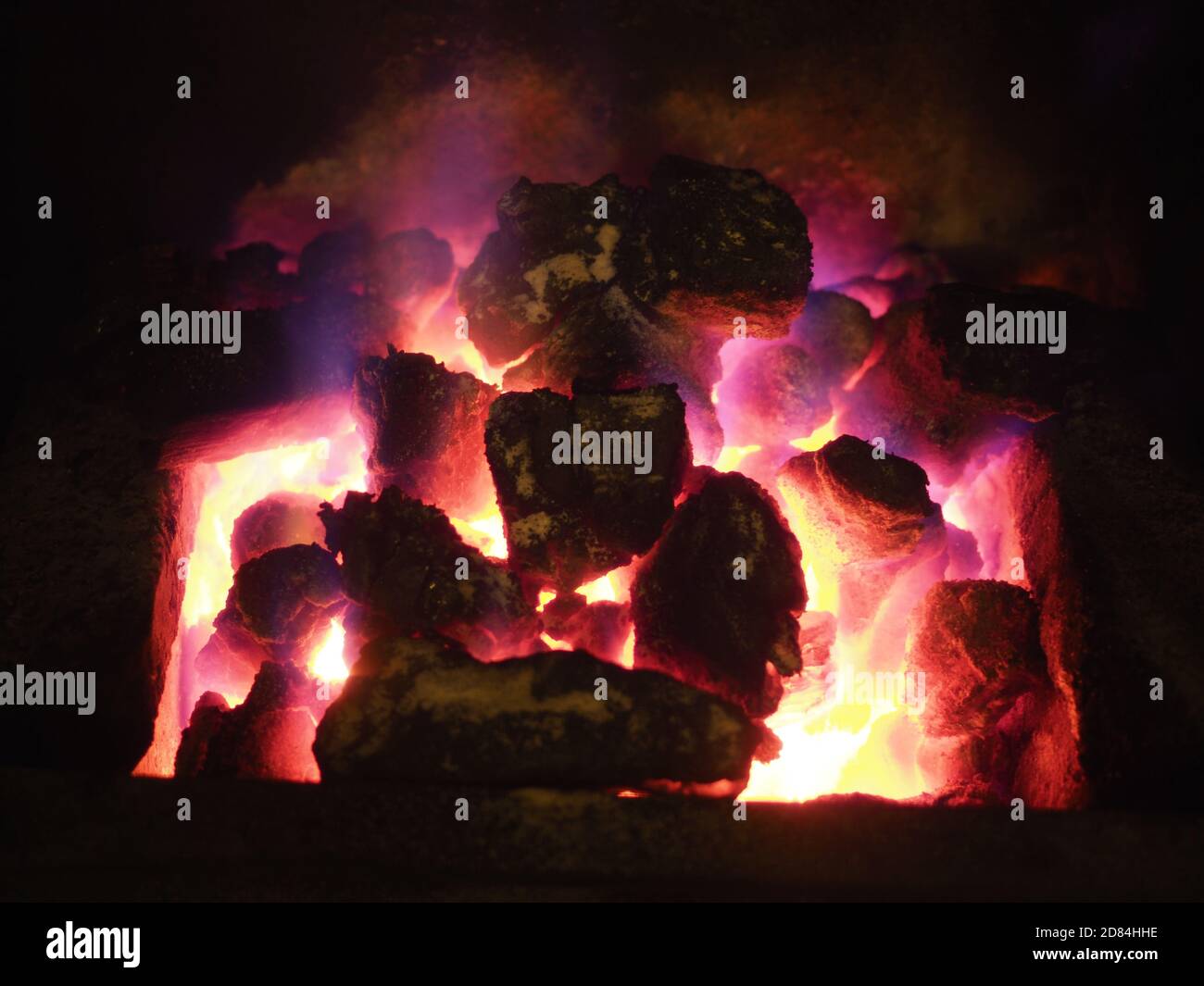 close up of a coal fire glowing red blue and orange as it burns Stock ...