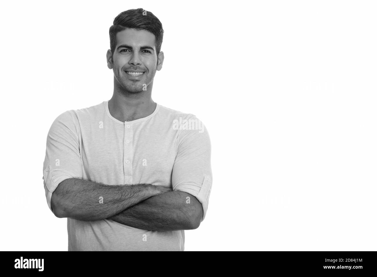 Handsome happy Persian man smiling with arms crossed Stock Photo - Alamy