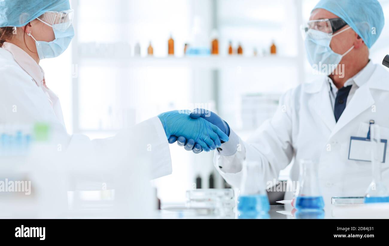 close up. scientists colleagues shaking hands with each other Stock ...