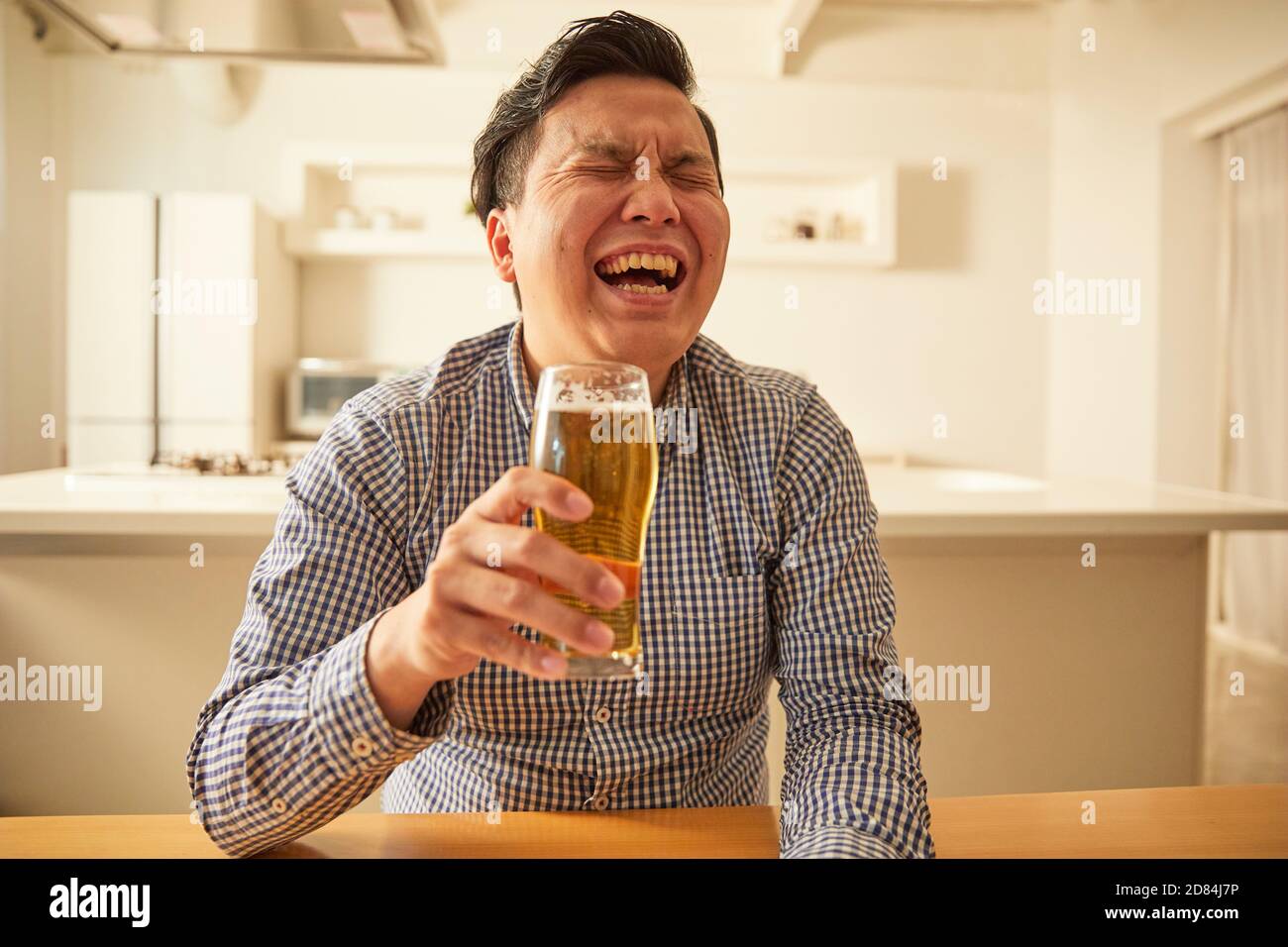 Japanese man drinking at home remote drinking Stock Photo - Alamy