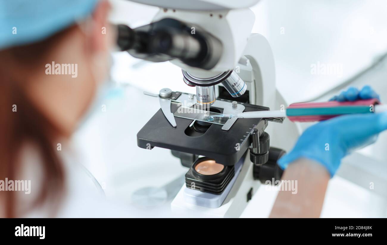 close up. researcher testing the blood under a microscope Stock Photo ...