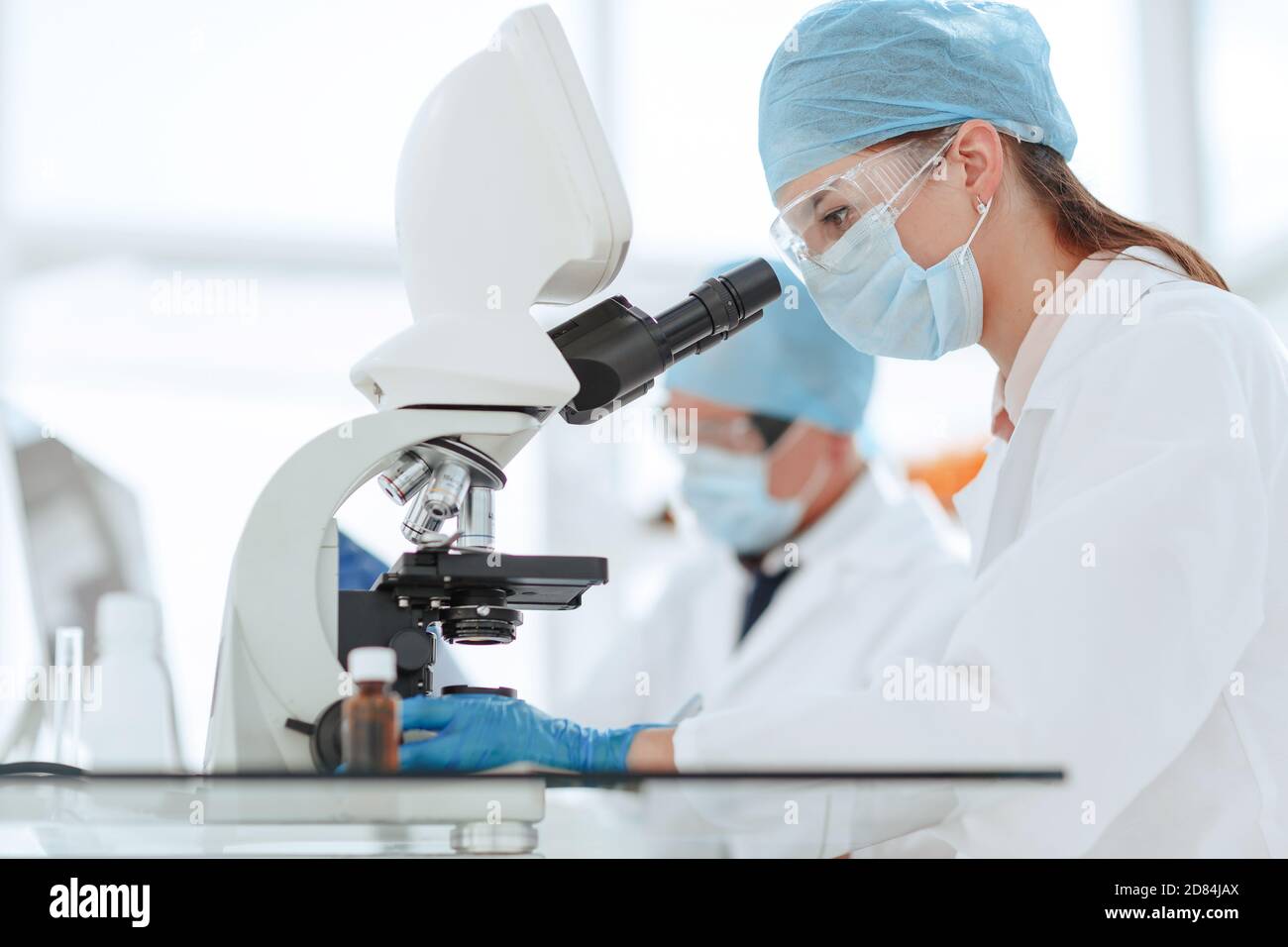 scientists testing the liquid and writing the results in a laboratory ...