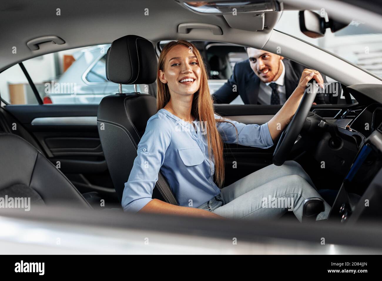 Happy woman new car owner sitting in driver seat Stock Photo - Alamy