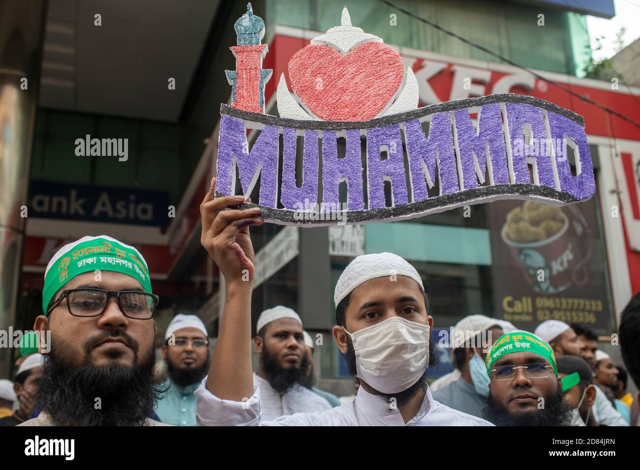 A Muslim protester displays a placard reading 'I love Muhammad' during ...