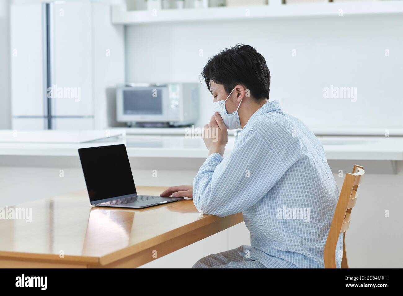 Sick Japanese man working from home Stock Photo - Alamy