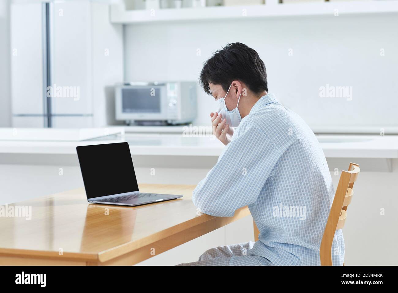 Sick Japanese man working from home Stock Photo - Alamy