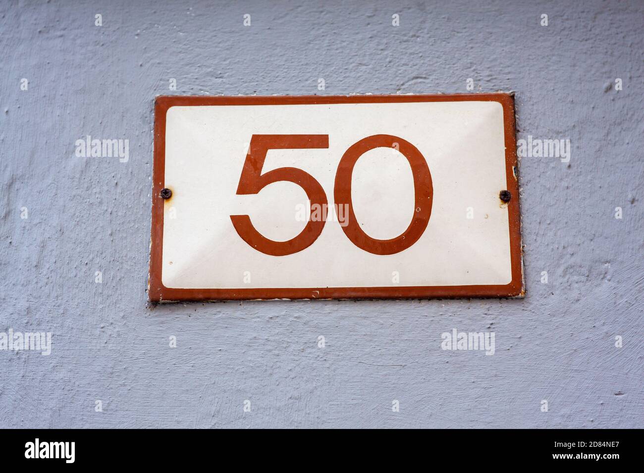 sign with the house number 50 on the stone wall Stock Photo - Alamy