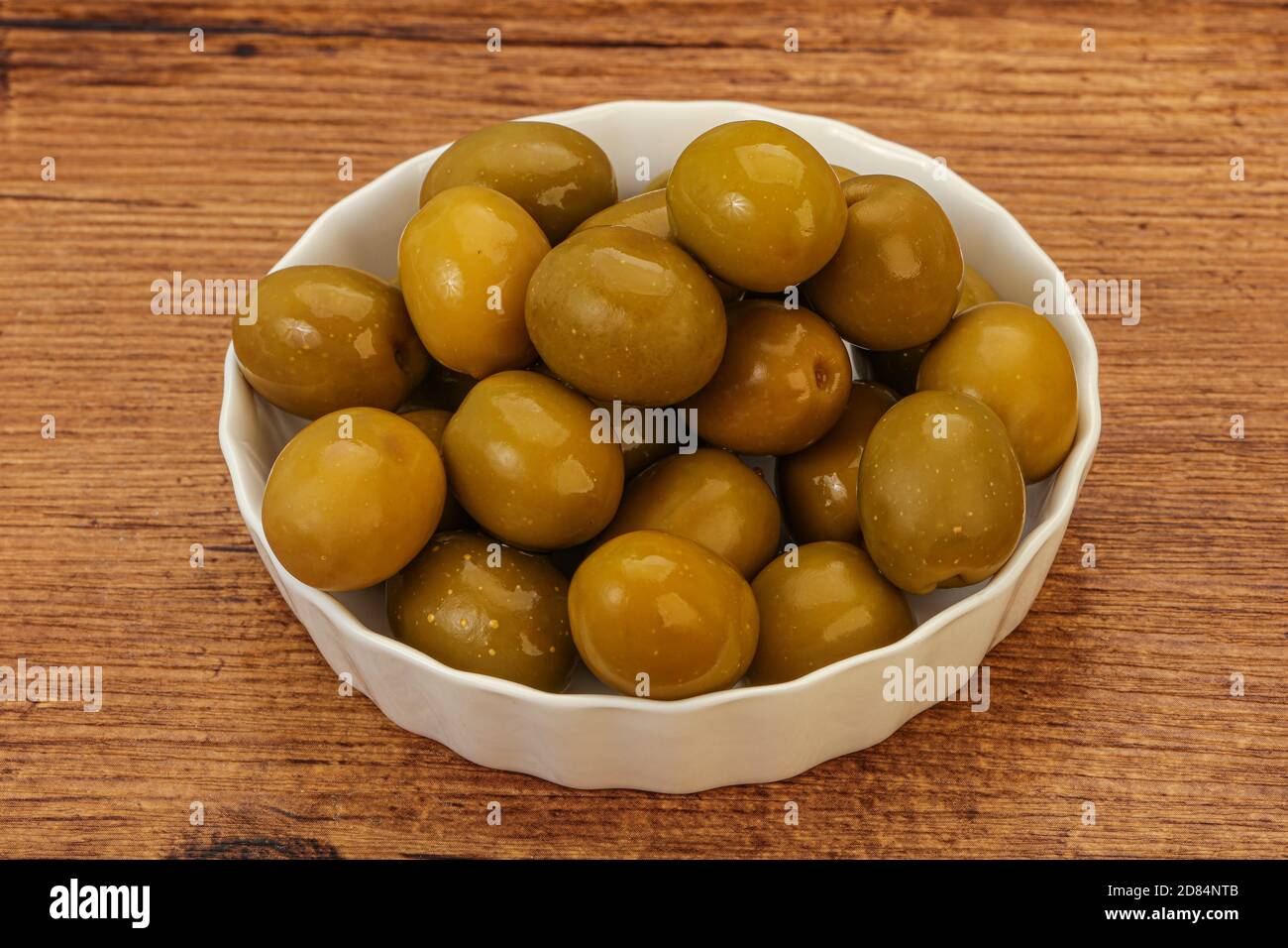 Green pickled olives heap in the bowl Stock Photo - Alamy