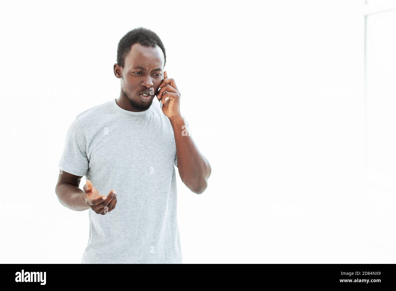serious young man talking on his smartphone Stock Photo - Alamy
