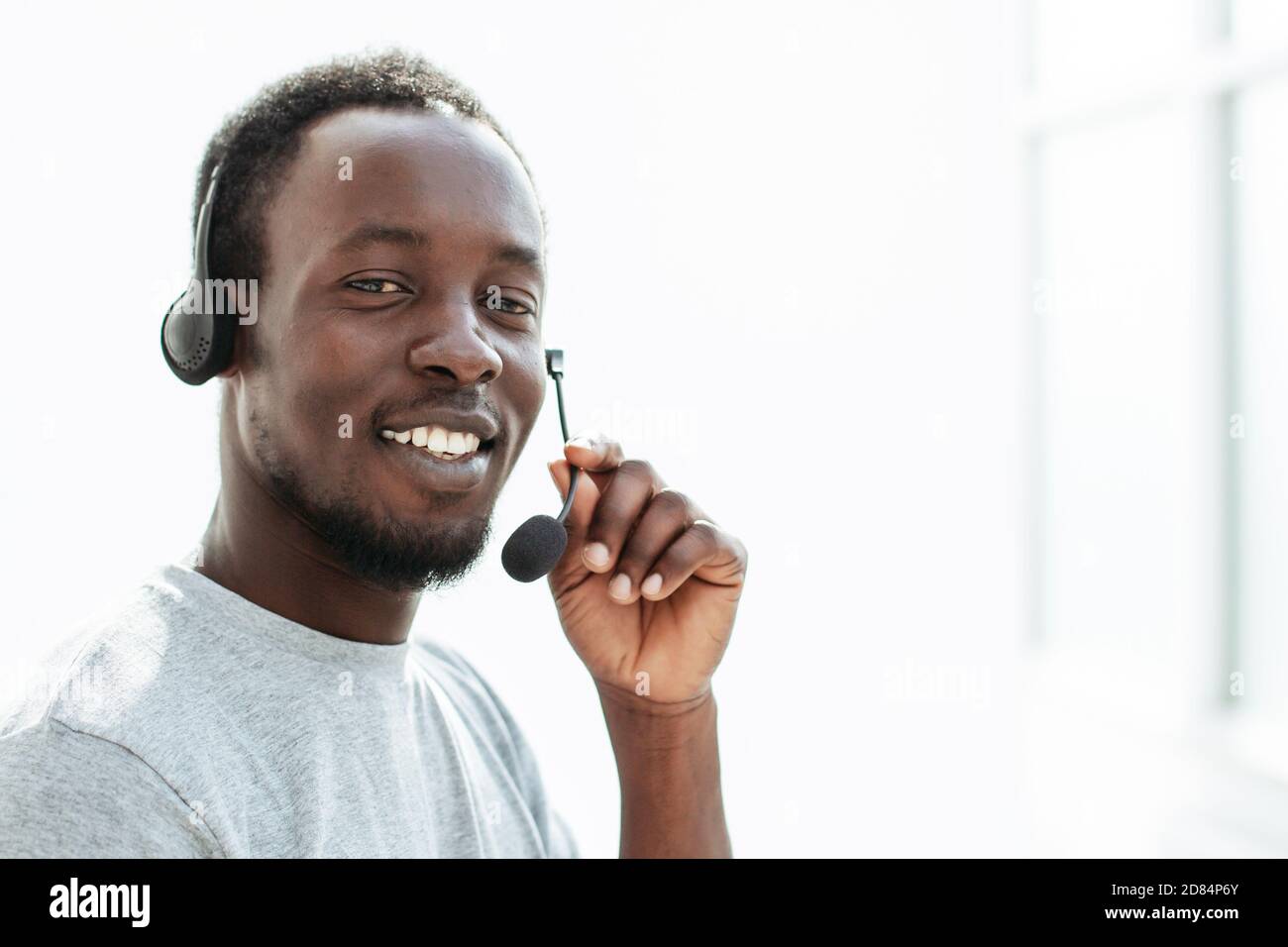 side view. young man with headset talking into microphone Stock Photo ...
