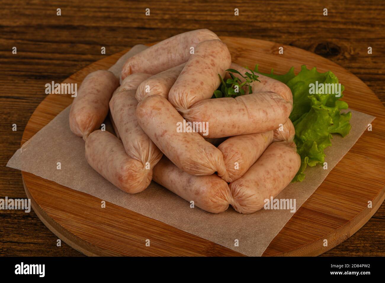 Raw natural chicken baby sausages for roast Stock Photo - Alamy