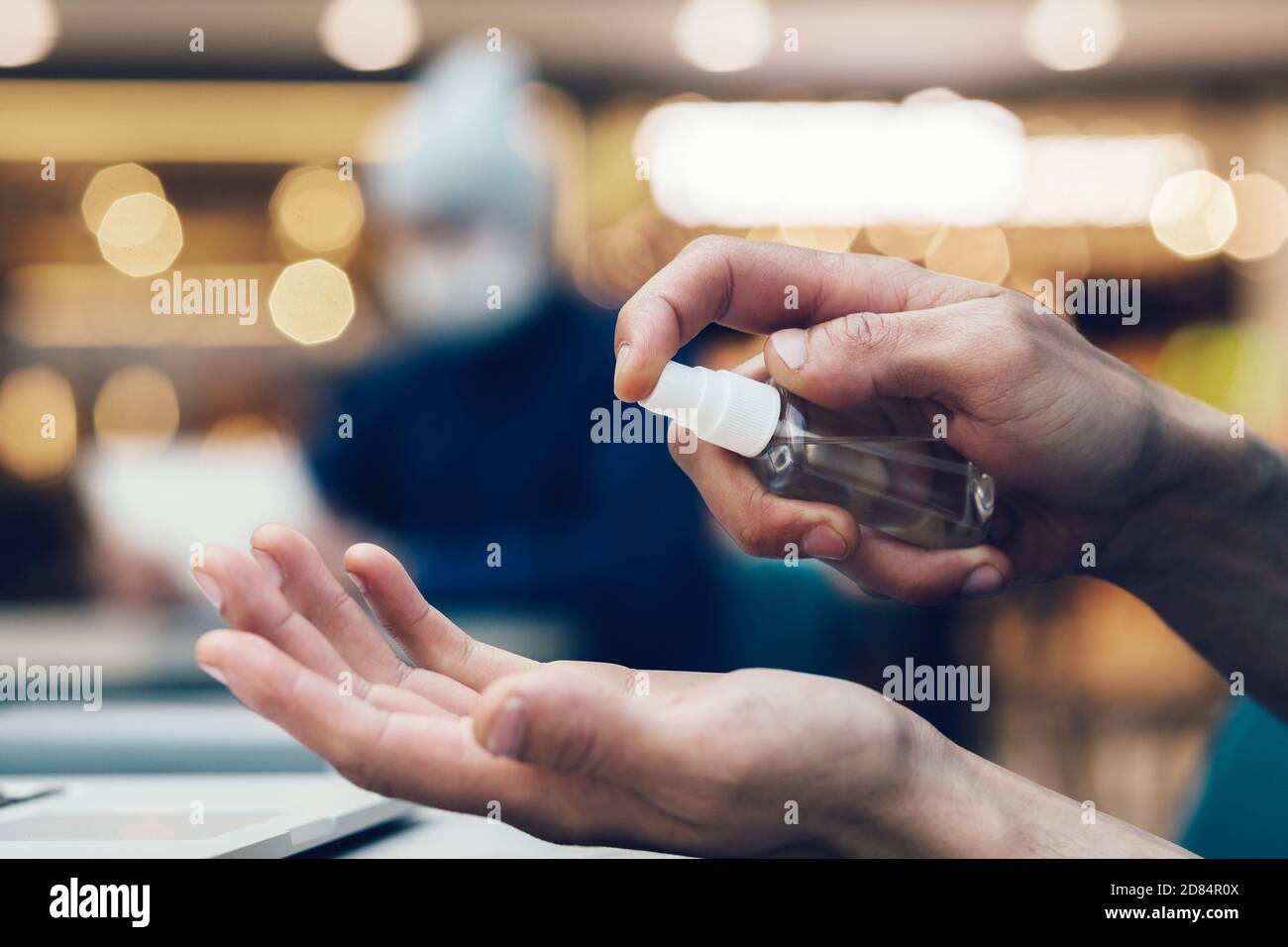 close up. man spraying antiseptic hand spray Stock Photo - Alamy
