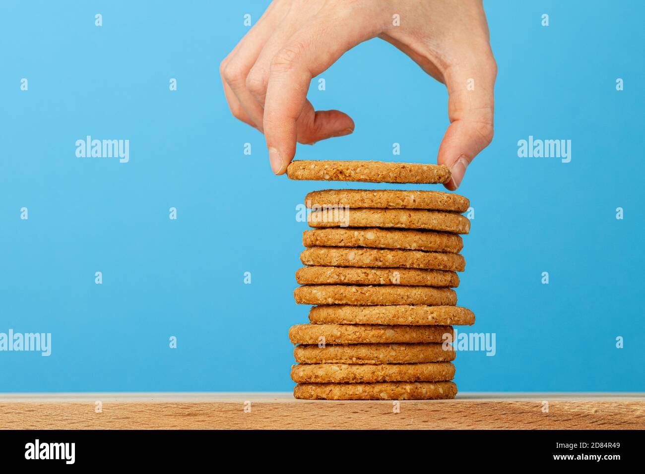Human hand taking oat cookie from a stack Stock Photo - Alamy