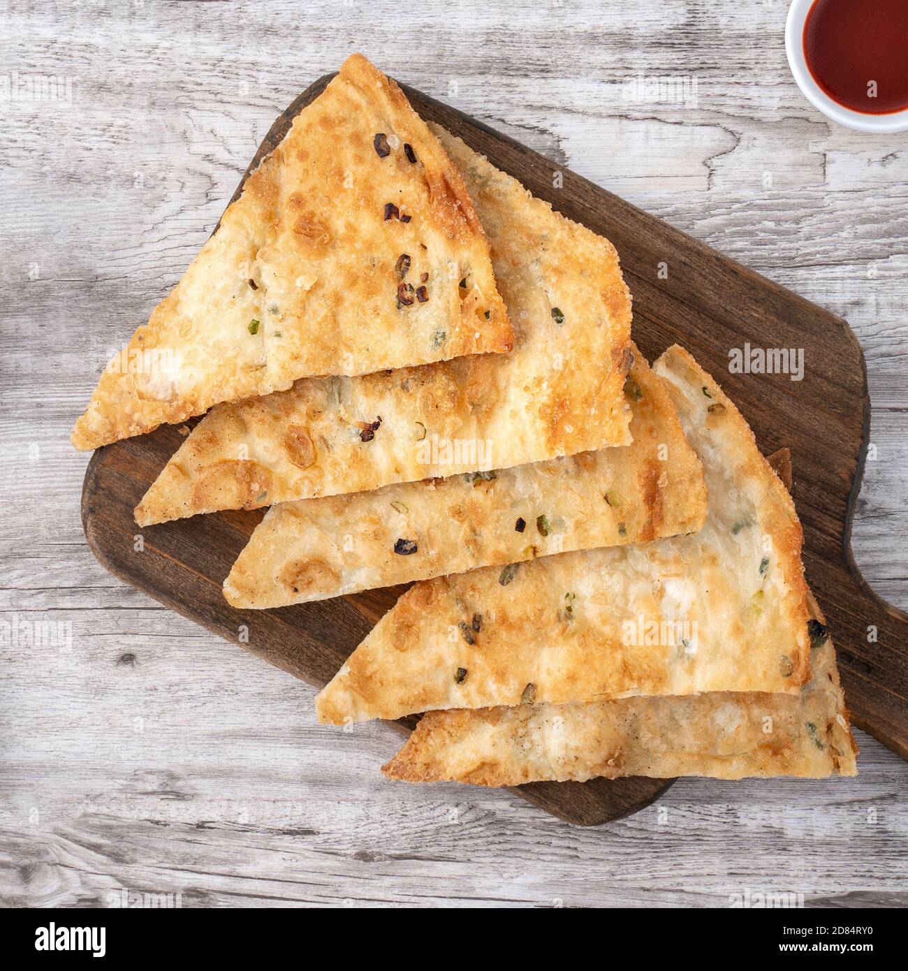 Taiwanese food - delicious flaky scallion pie pancakes on bright wooden ...