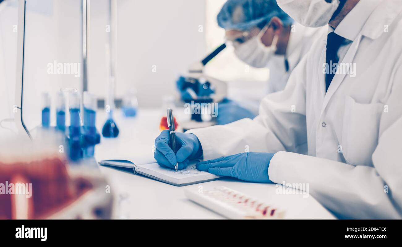close up. scientist recording the results of the study in a laboratory ...
