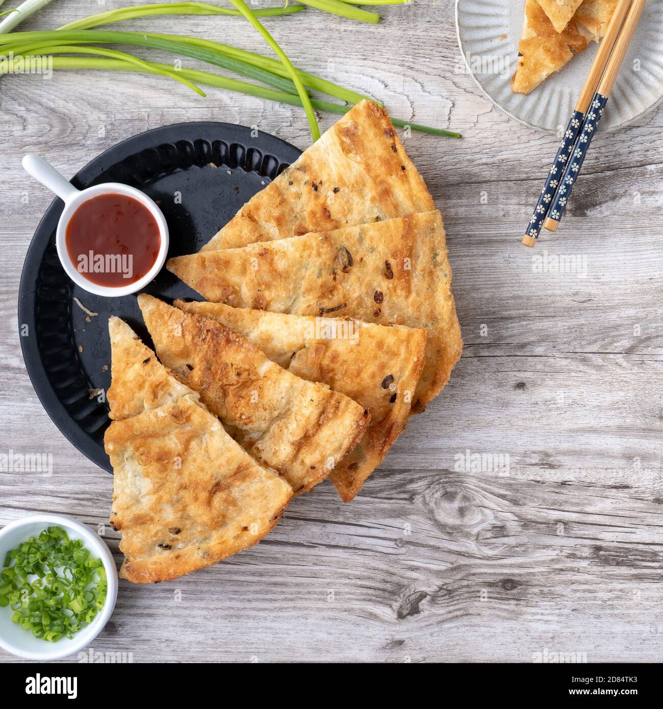 Taiwanese food - delicious flaky scallion pie pancakes on bright wooden ...