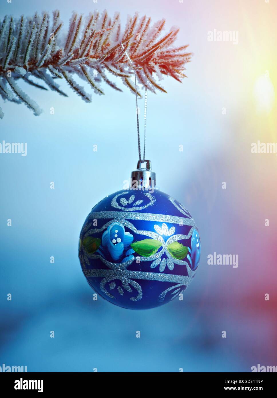 bright Christmas bauble from a snow covered Christmas Tree Branch Stock ...