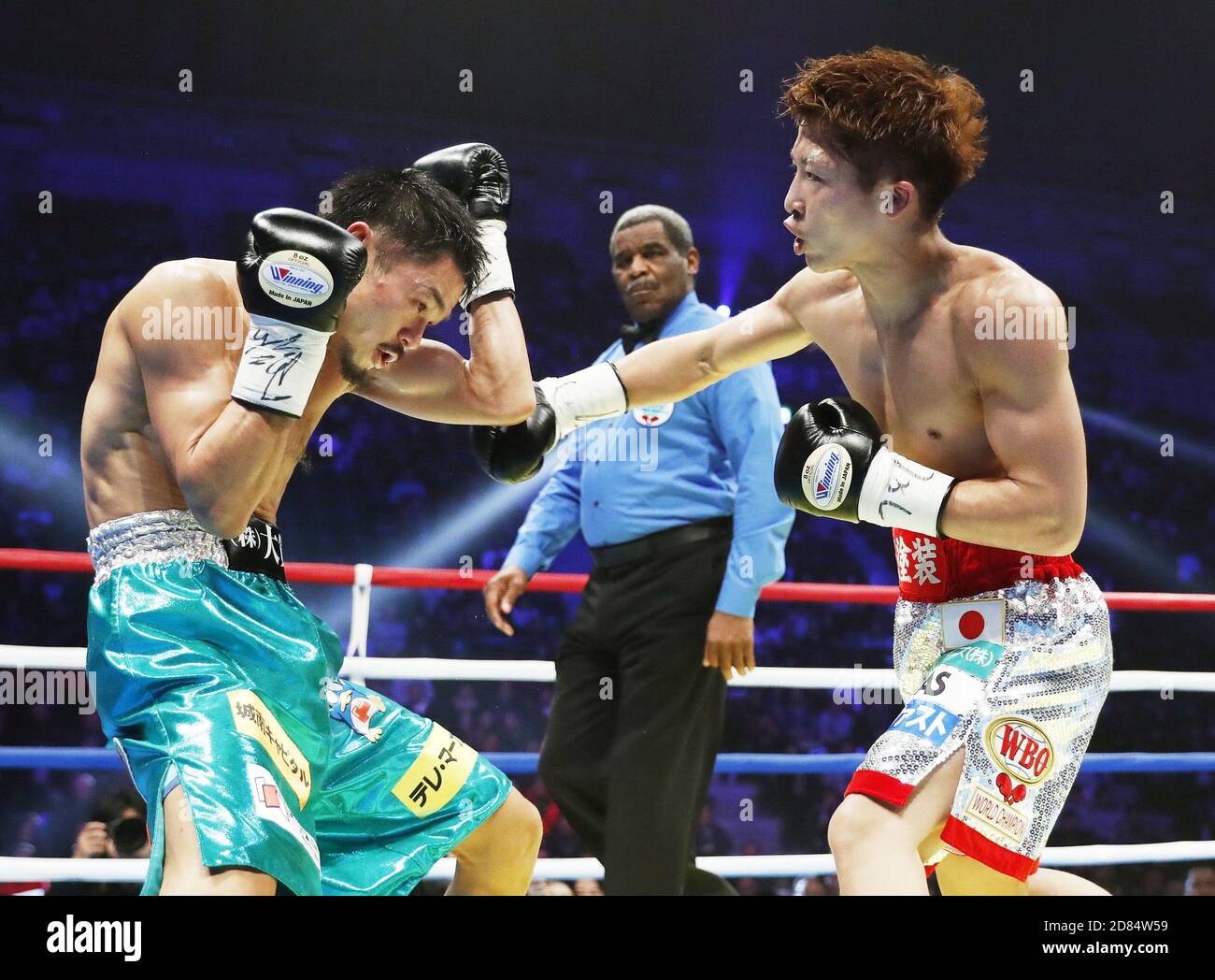 File photo taken in December 2016 shows Naoya Inoue (R) throws a punch ...