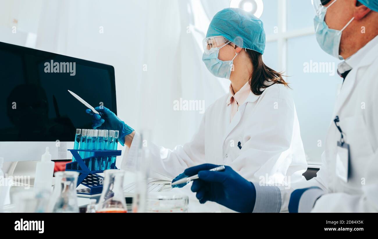 group of scientists looking at a computer screen in the laboratory ...