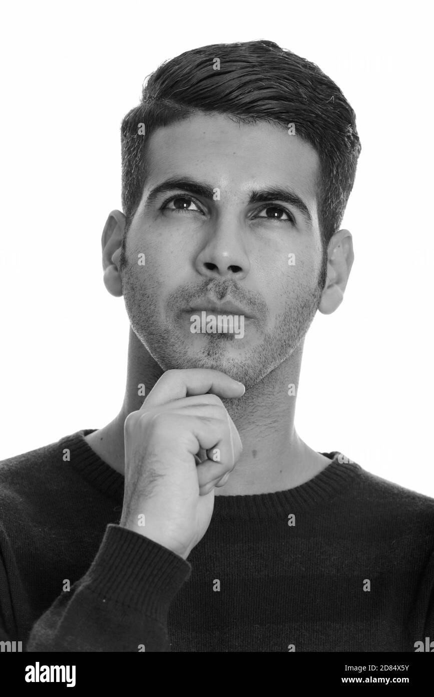 Face of young handsome Persian man thinking Stock Photo - Alamy