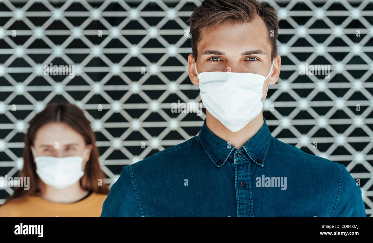 woman and a man in protective masks standing at a distance Stock Photo ...