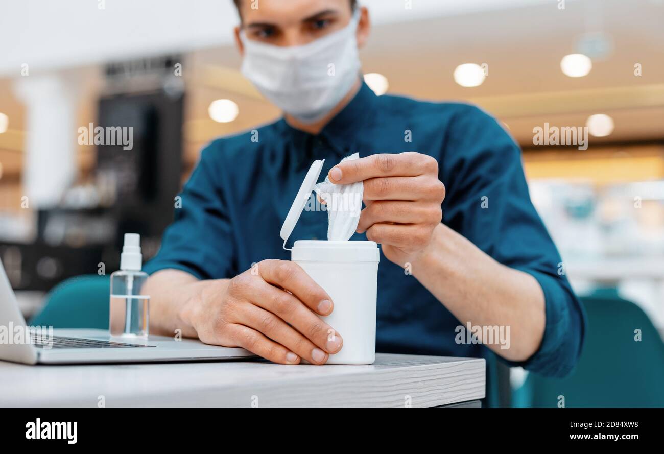 young man using antiseptic wipes in the workplace Stock Photo - Alamy