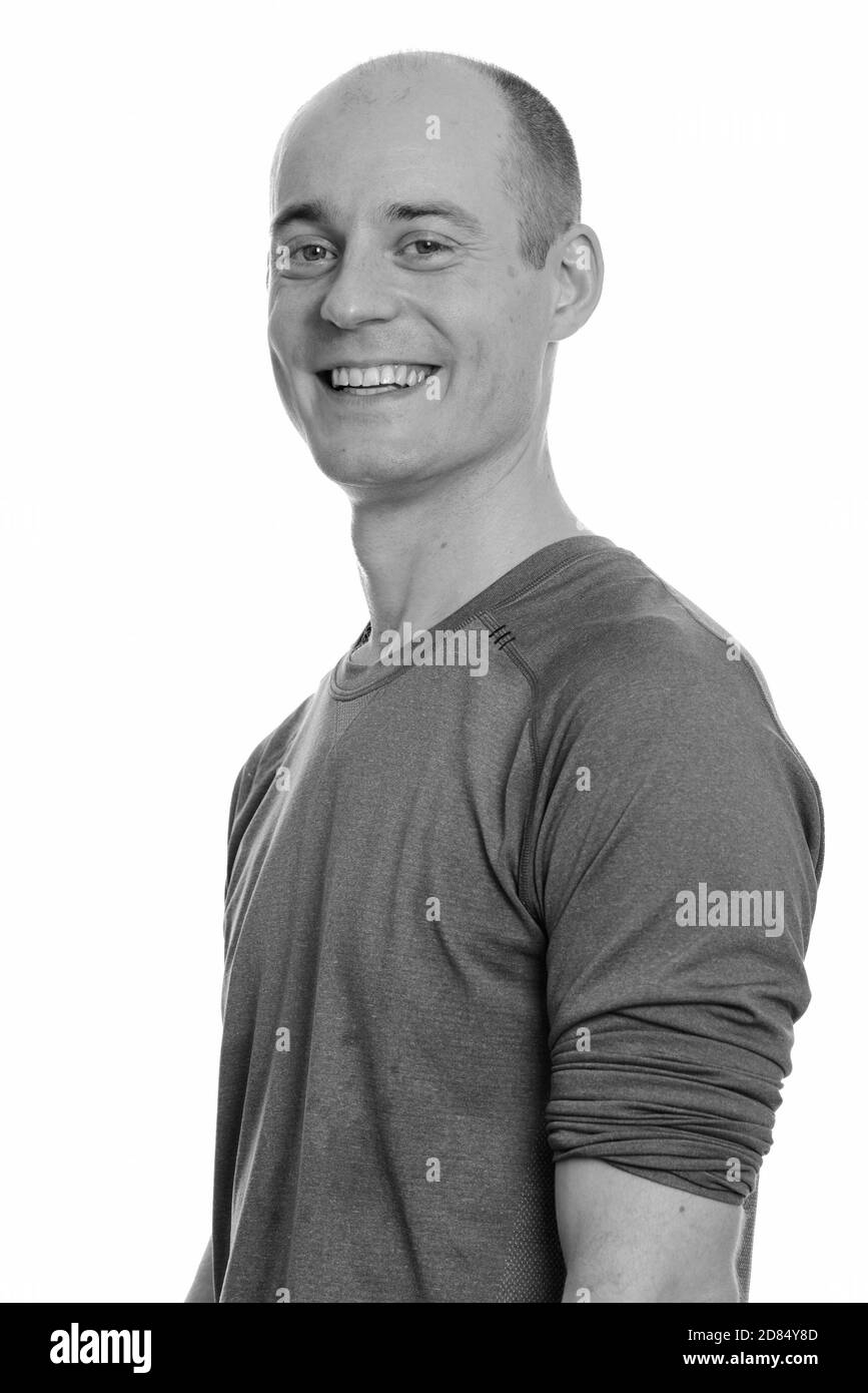 Profile view of happy handsome bald man looking at camera Stock Photo ...