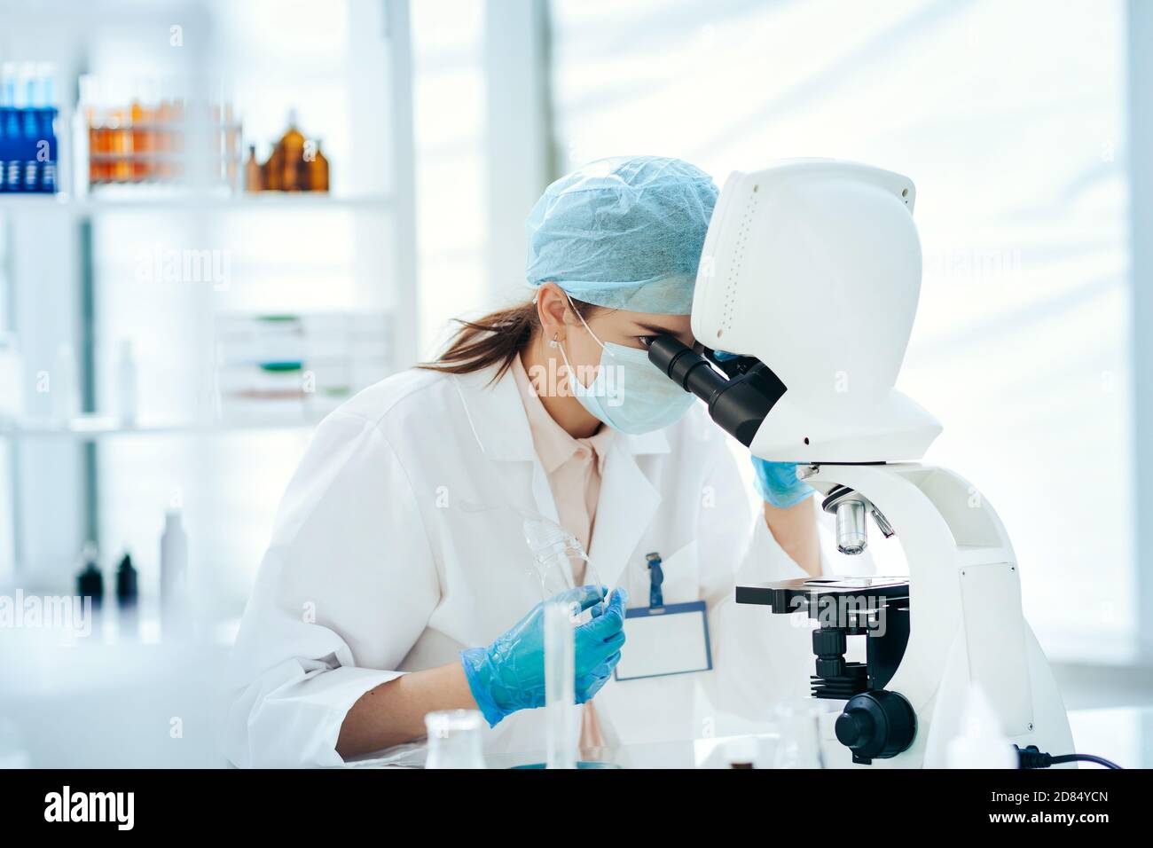 close up. female scientist looking through a microscope Stock Photo - Alamy