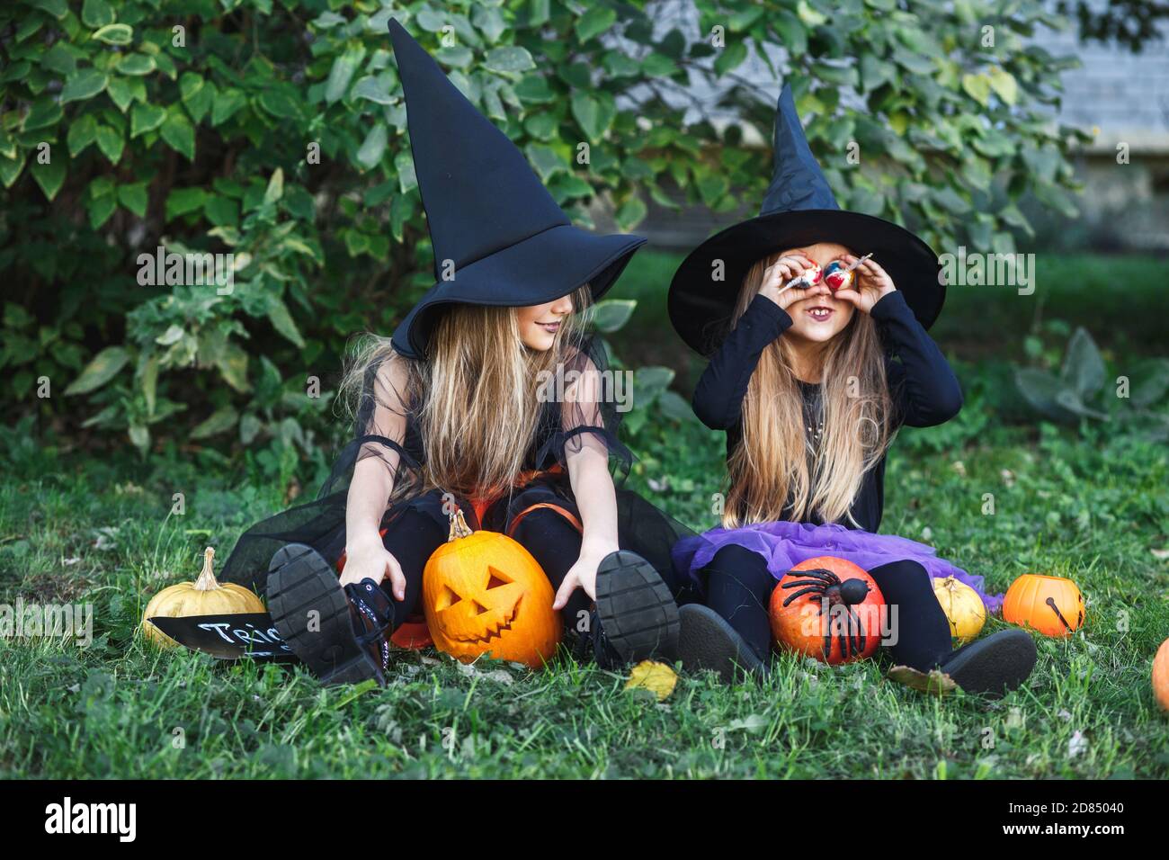Happy Halloween. Children in suits and with pumpkins having fun outdoor ...
