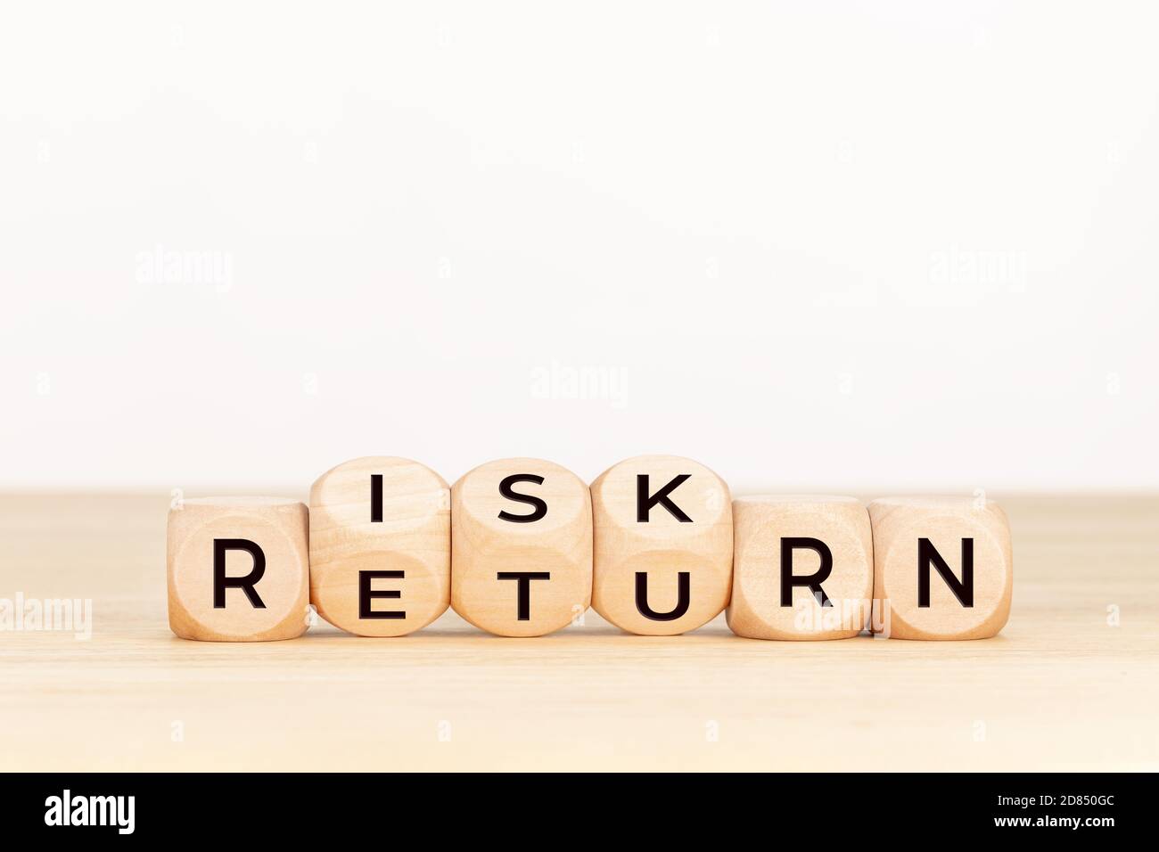 Risk Return concept. Wooden block with text on table. Copy space Stock ...