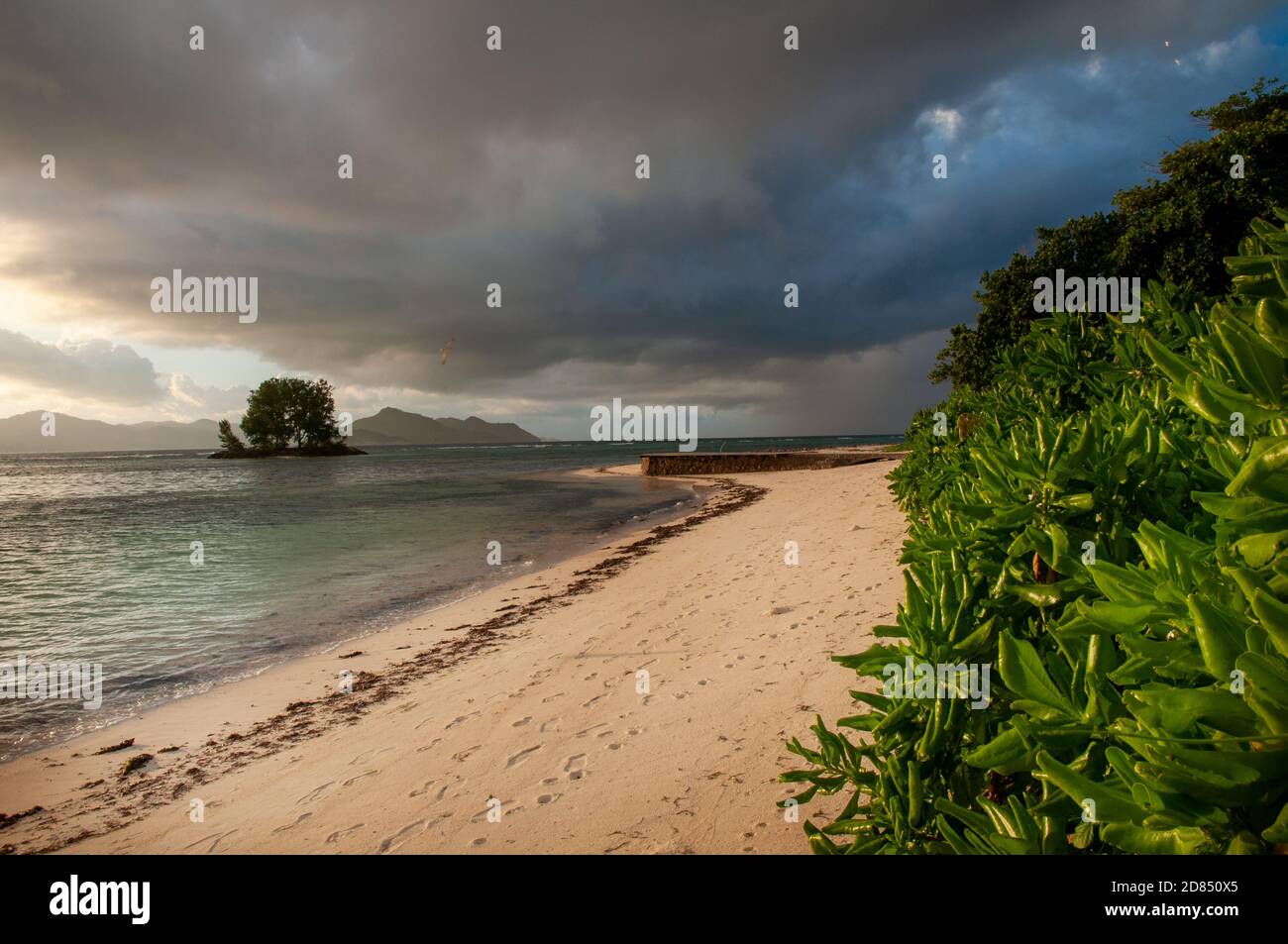 Summer weather in a tropical beach with sun over the horizon sea and ...