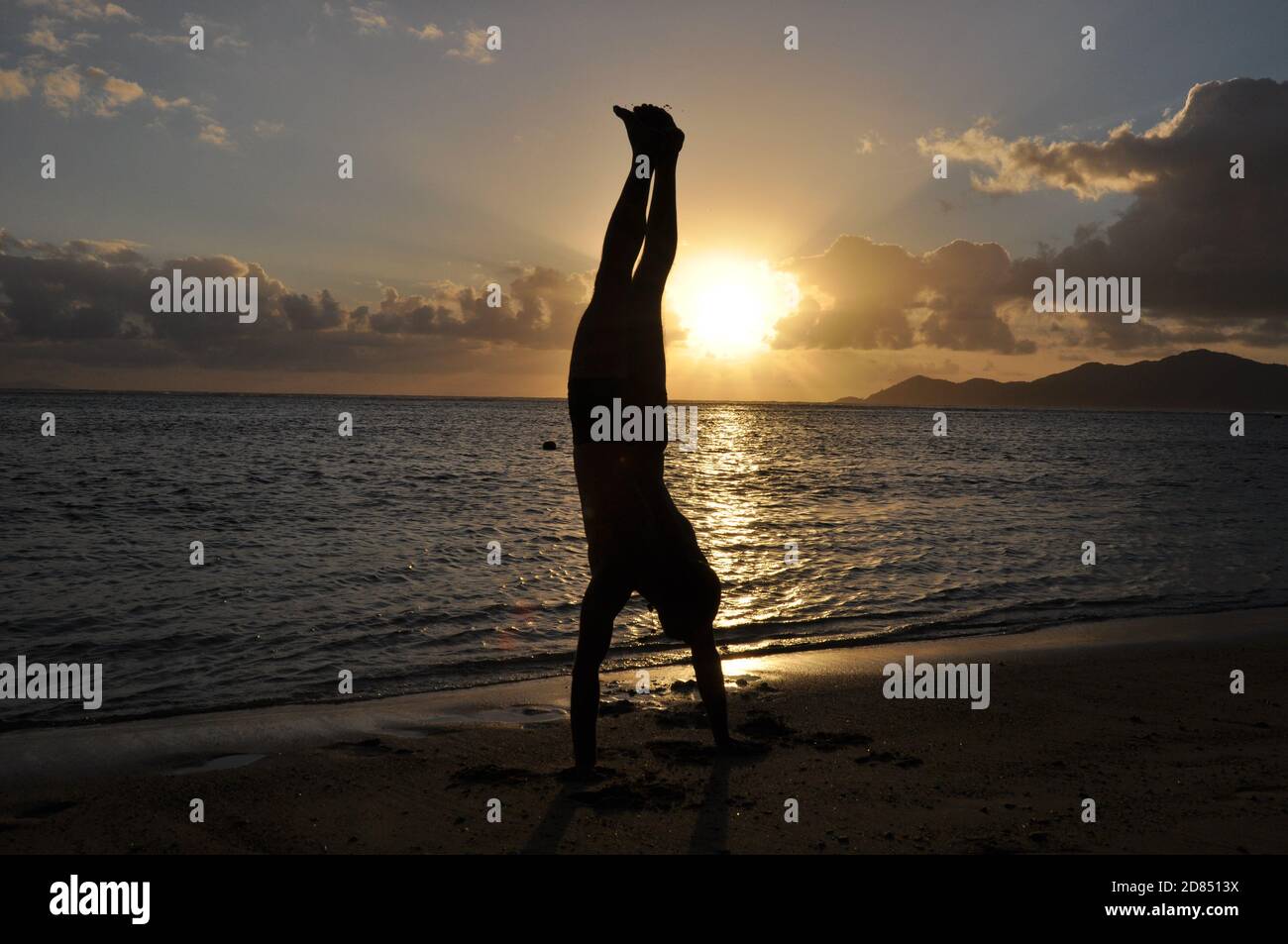 Silhouette Doing Handstand On Beach At Sunset Stock Photo - Alamy