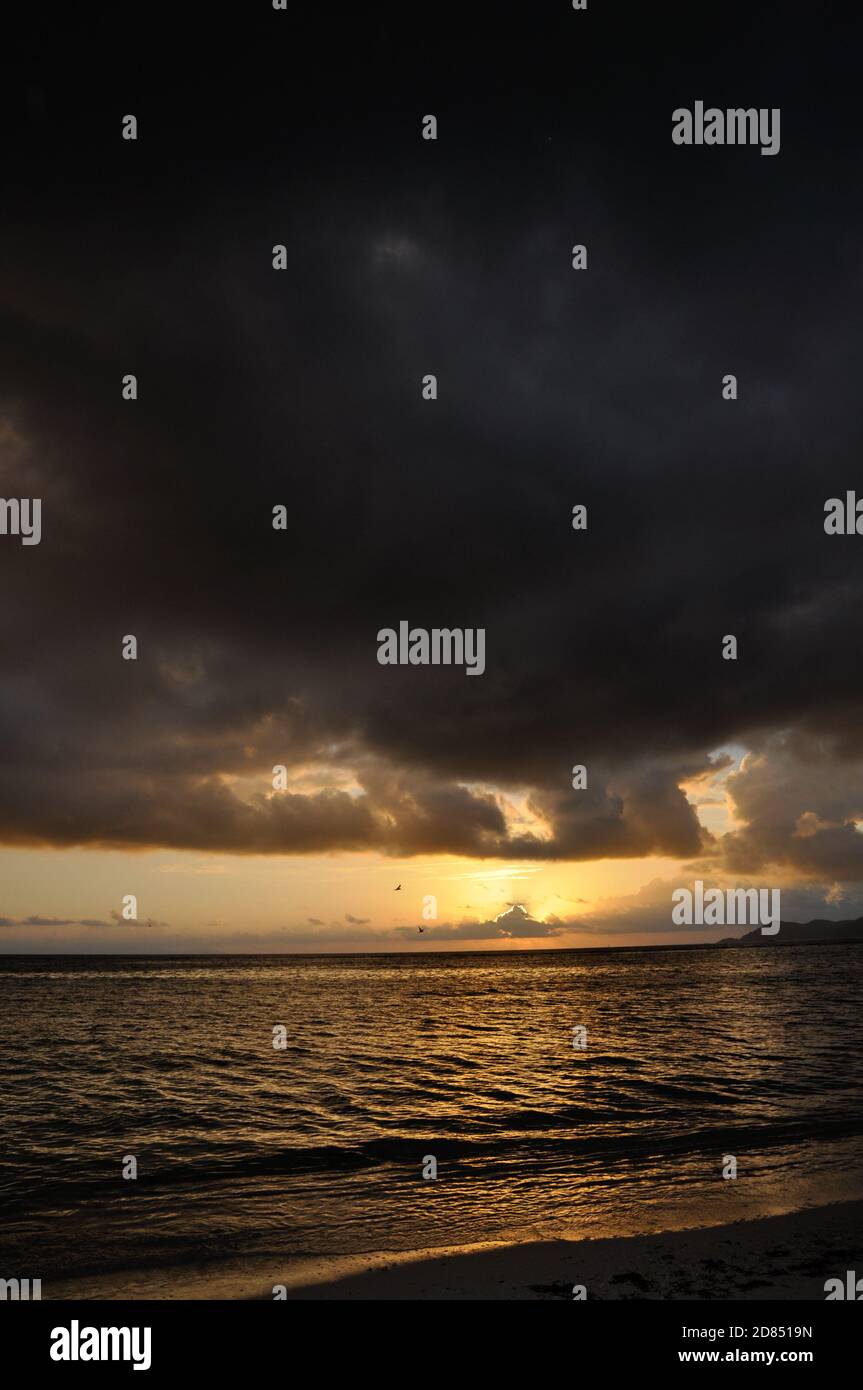 Dark clouds at sunset on the ocean Stock Photo - Alamy
