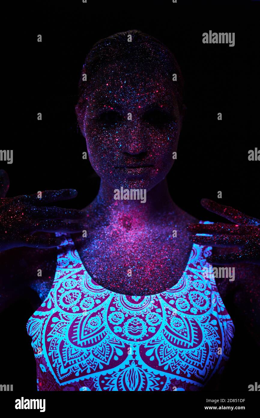 Art woman cosmos in ultraviolet light. Entire body is covered with ...