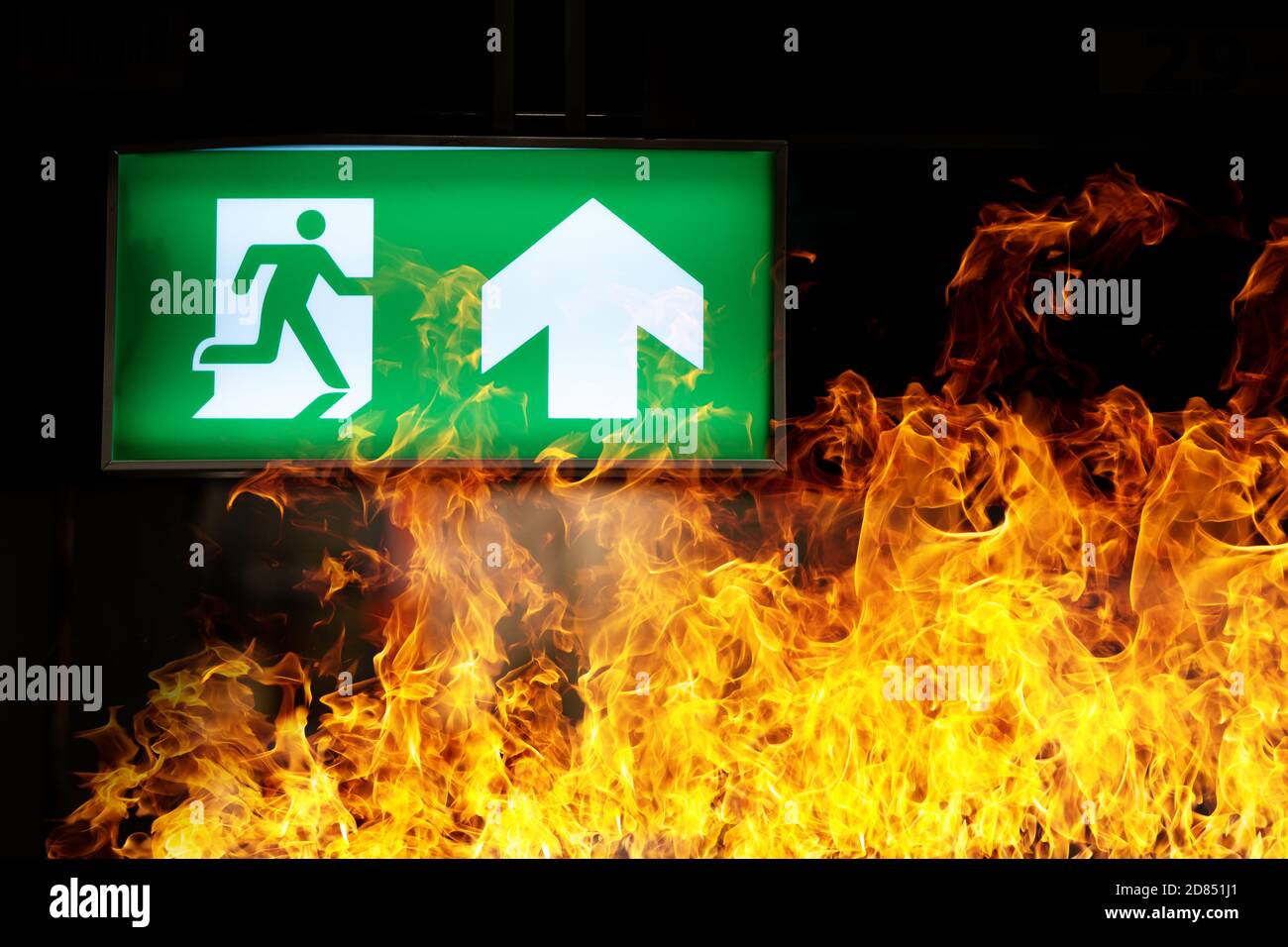 Green fire escape sign hang on the ceiling in the Warehouse. The ...