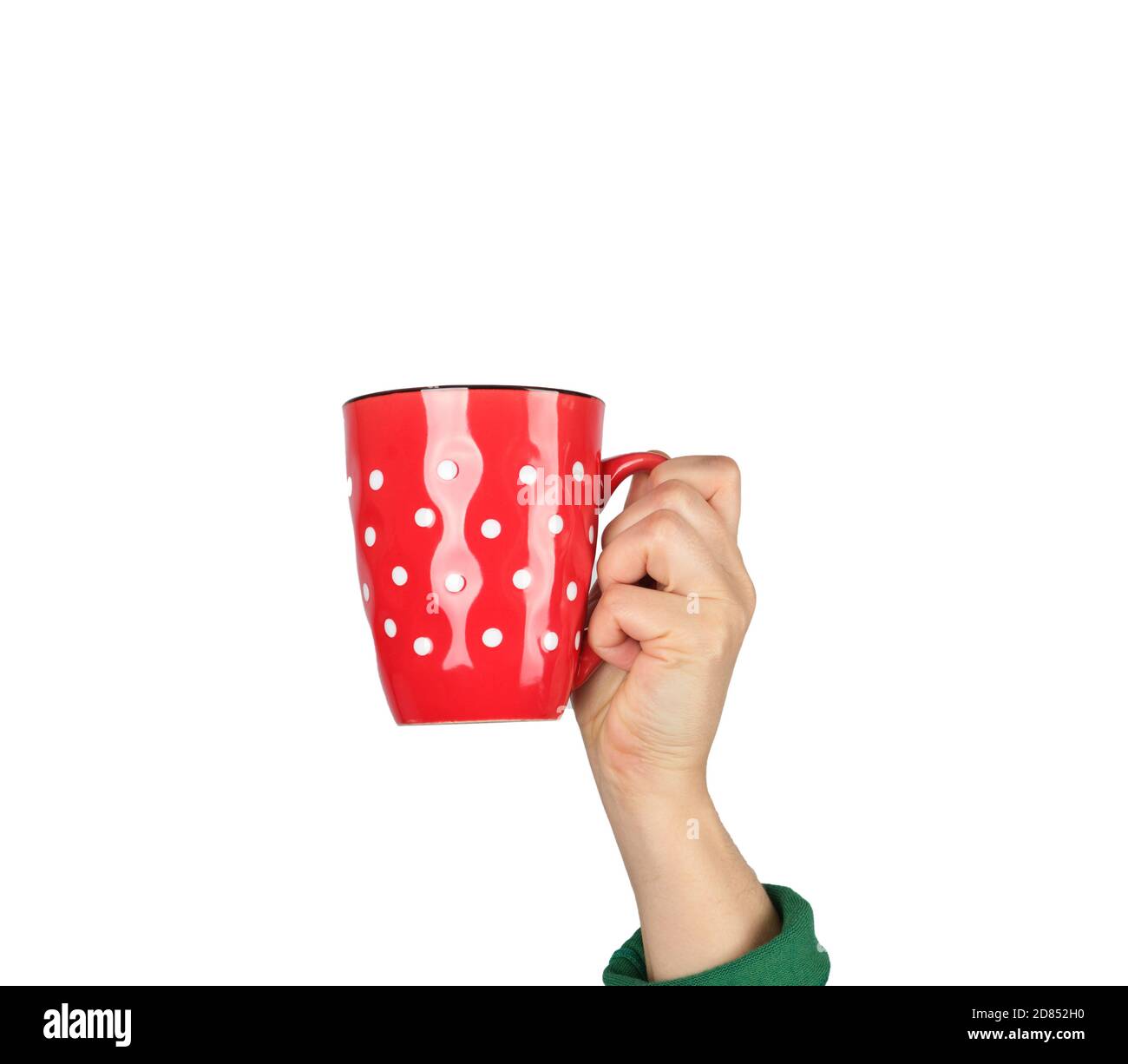 red ceramic cup in a female hand on a white background, hand is raised ...